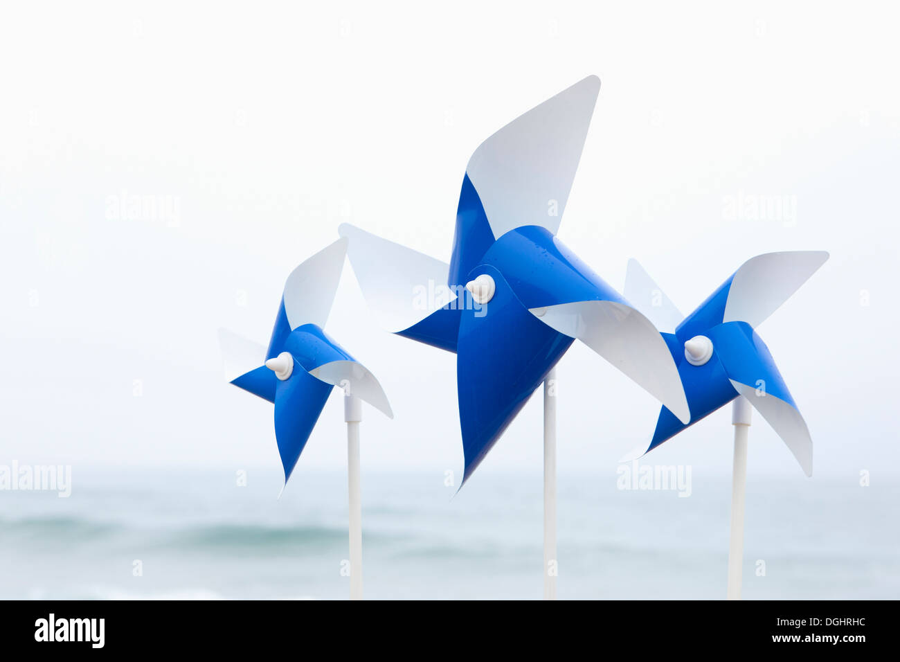 toy wind mills on a beach Stock Photo - Alamy