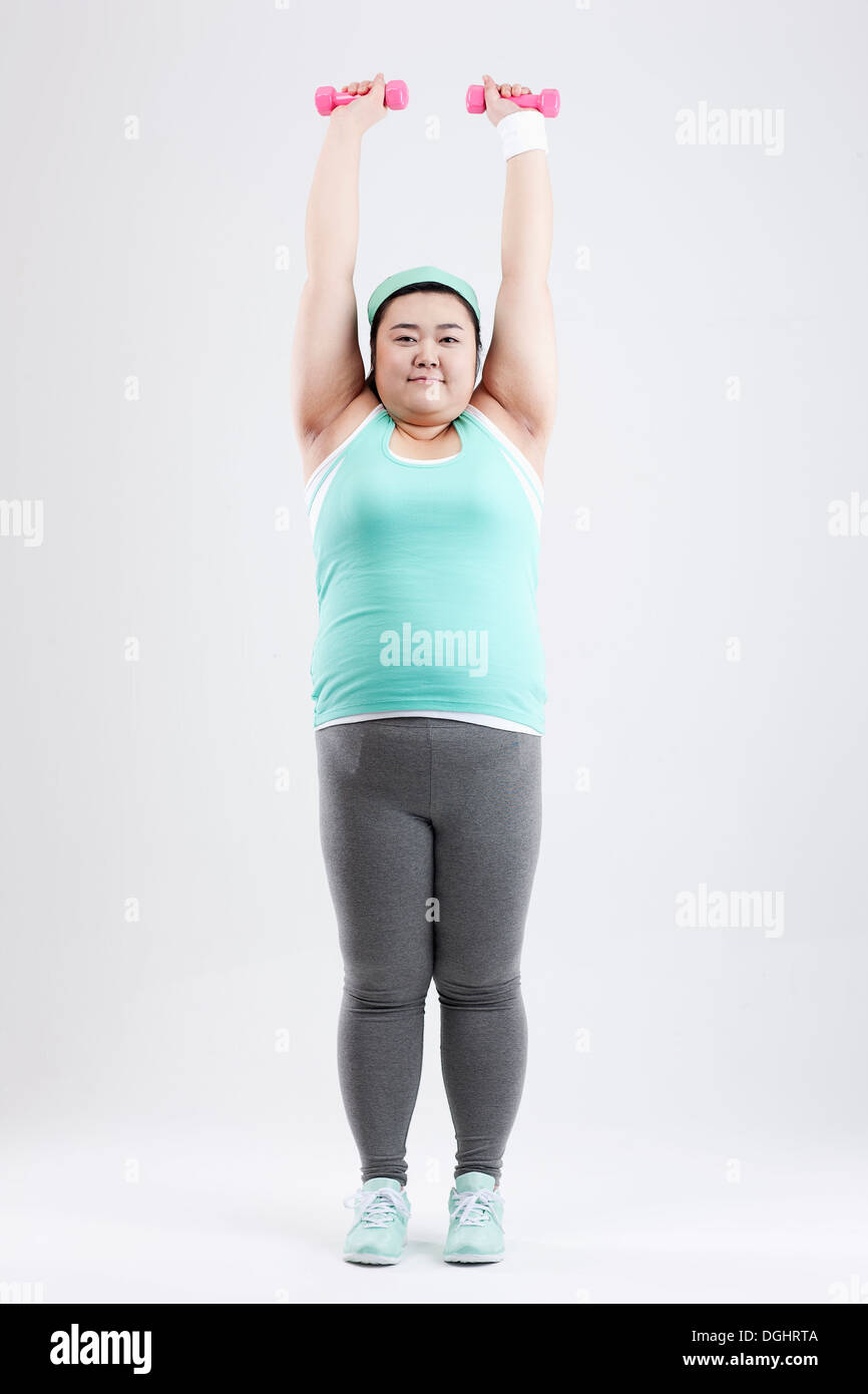 a fat girl working out in a gym outfit Stock Photo - Alamy