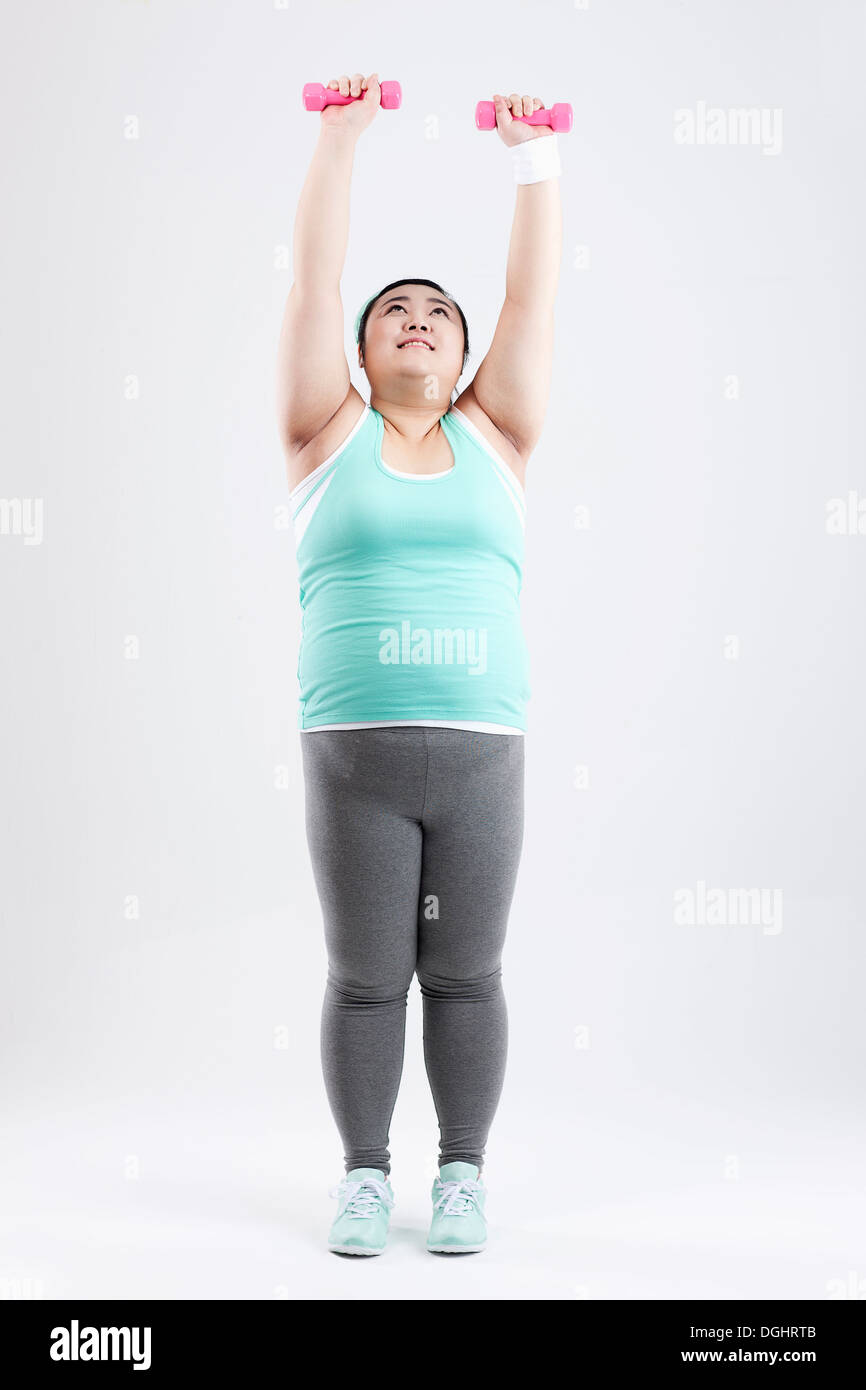 a fat girl working out in a gym outfit Stock Photo - Alamy