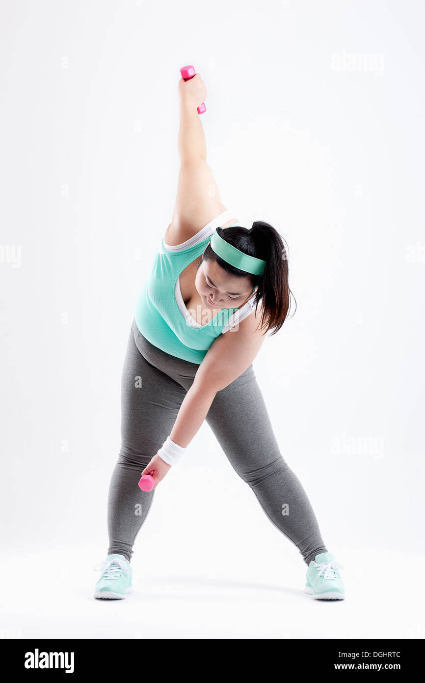 a fat girl working out in a gym outfit Stock Photo - Alamy