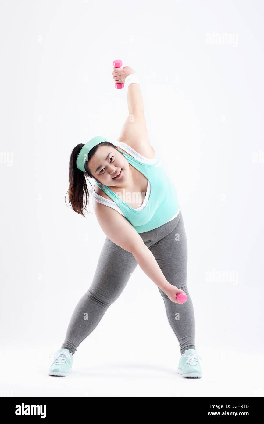 a fat girl working out in a gym outfit Stock Photo - Alamy