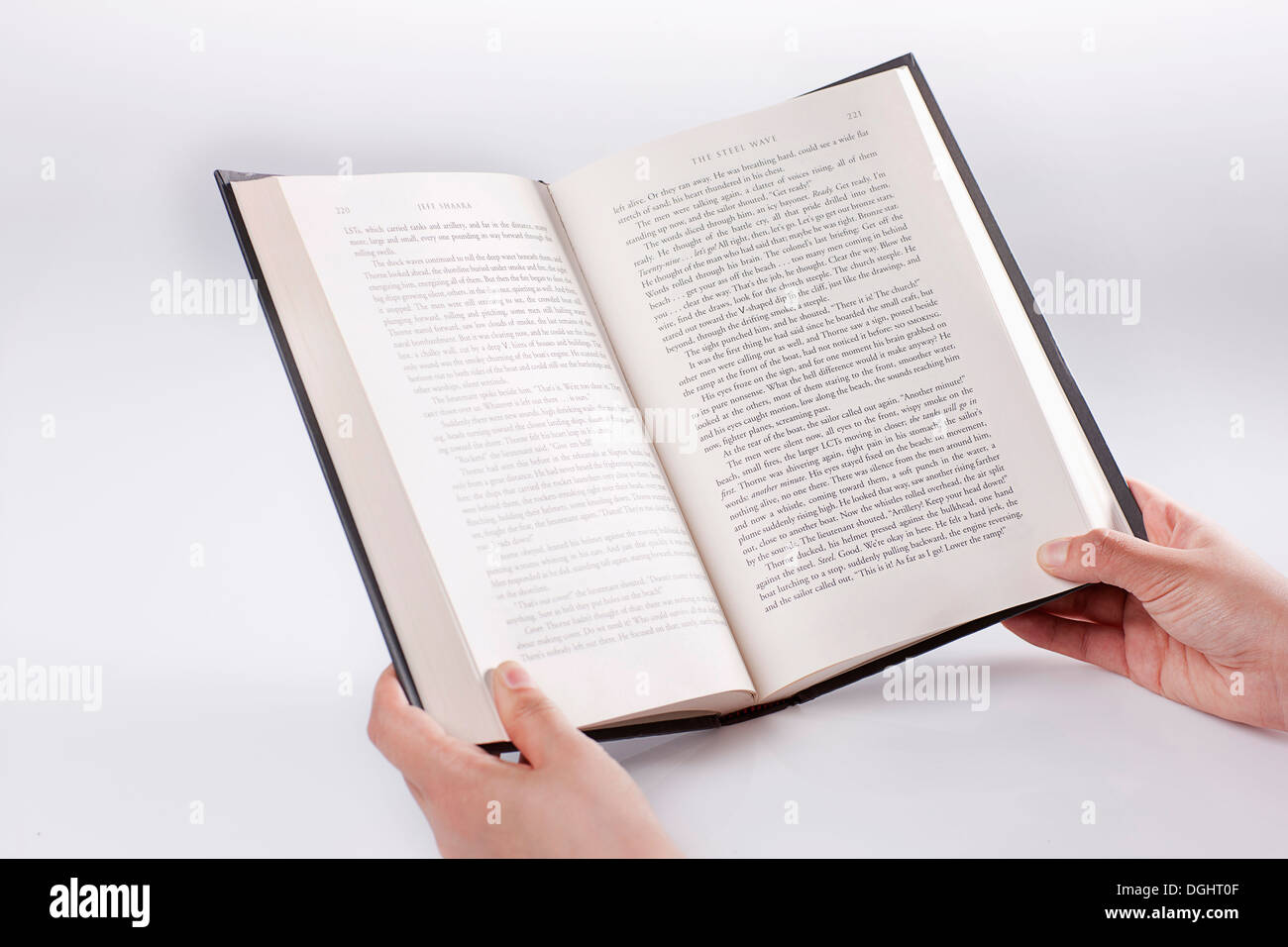 a pair of hands reading a book Stock Photo - Alamy