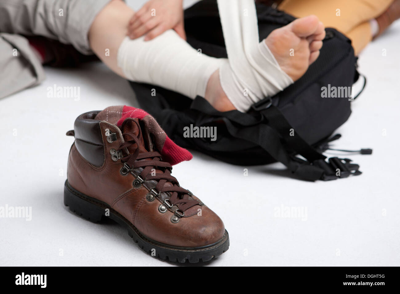 a woman wrapping a hiker man's leg in a gauze Stock Photo - Alamy