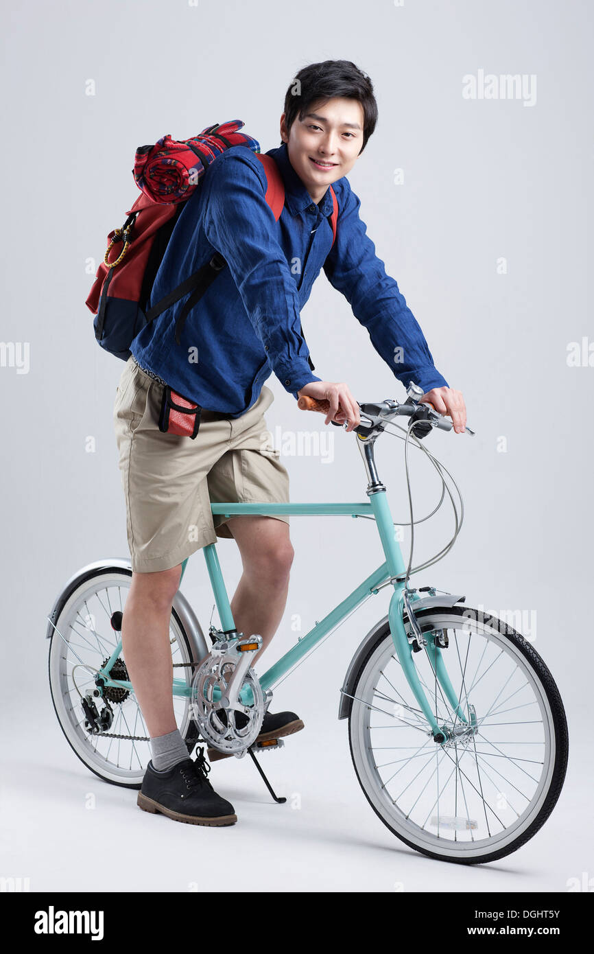 a man sitting on a bicycle Stock Photo - Alamy