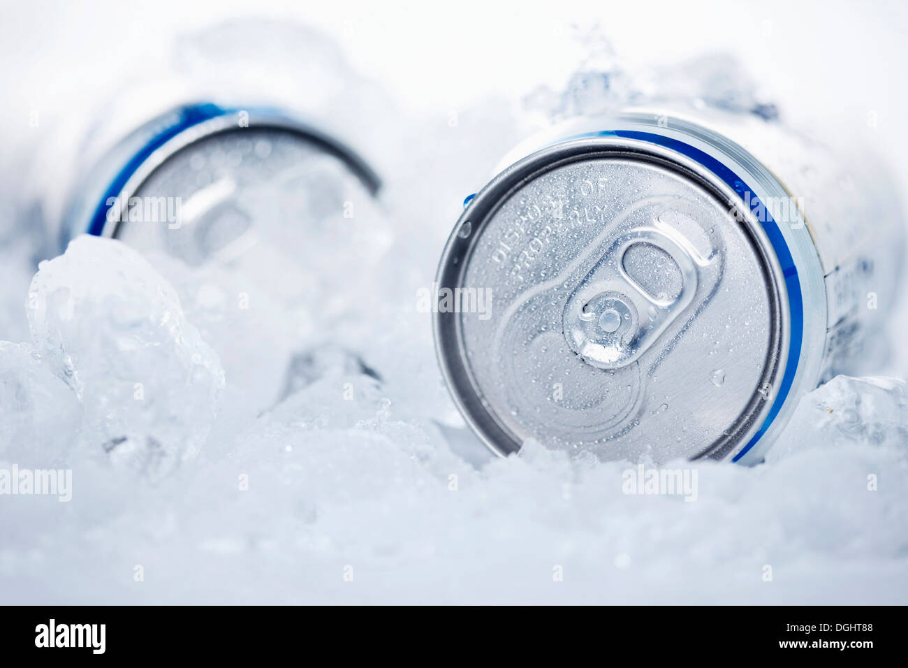 two drink cans in ice Stock Photo - Alamy