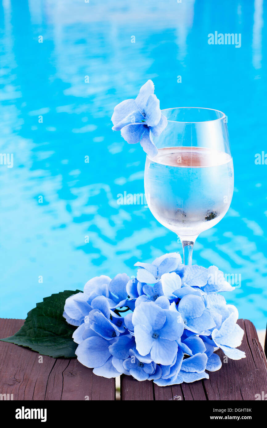 a glass of water next to a pool Stock Photo - Alamy