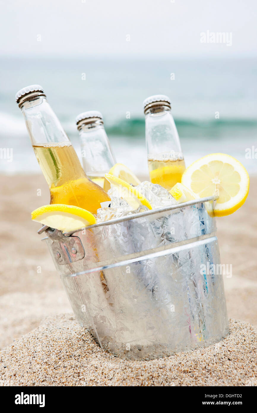 several beers in a bucket of ice Stock Photo - Alamy