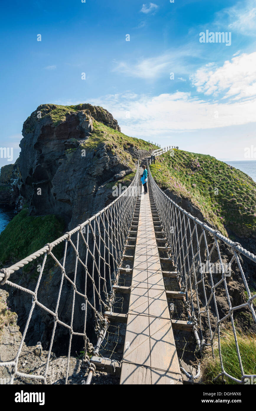 Carrick-a-Rede Bridge, woman standing on the suspension bridge, Moyle ...