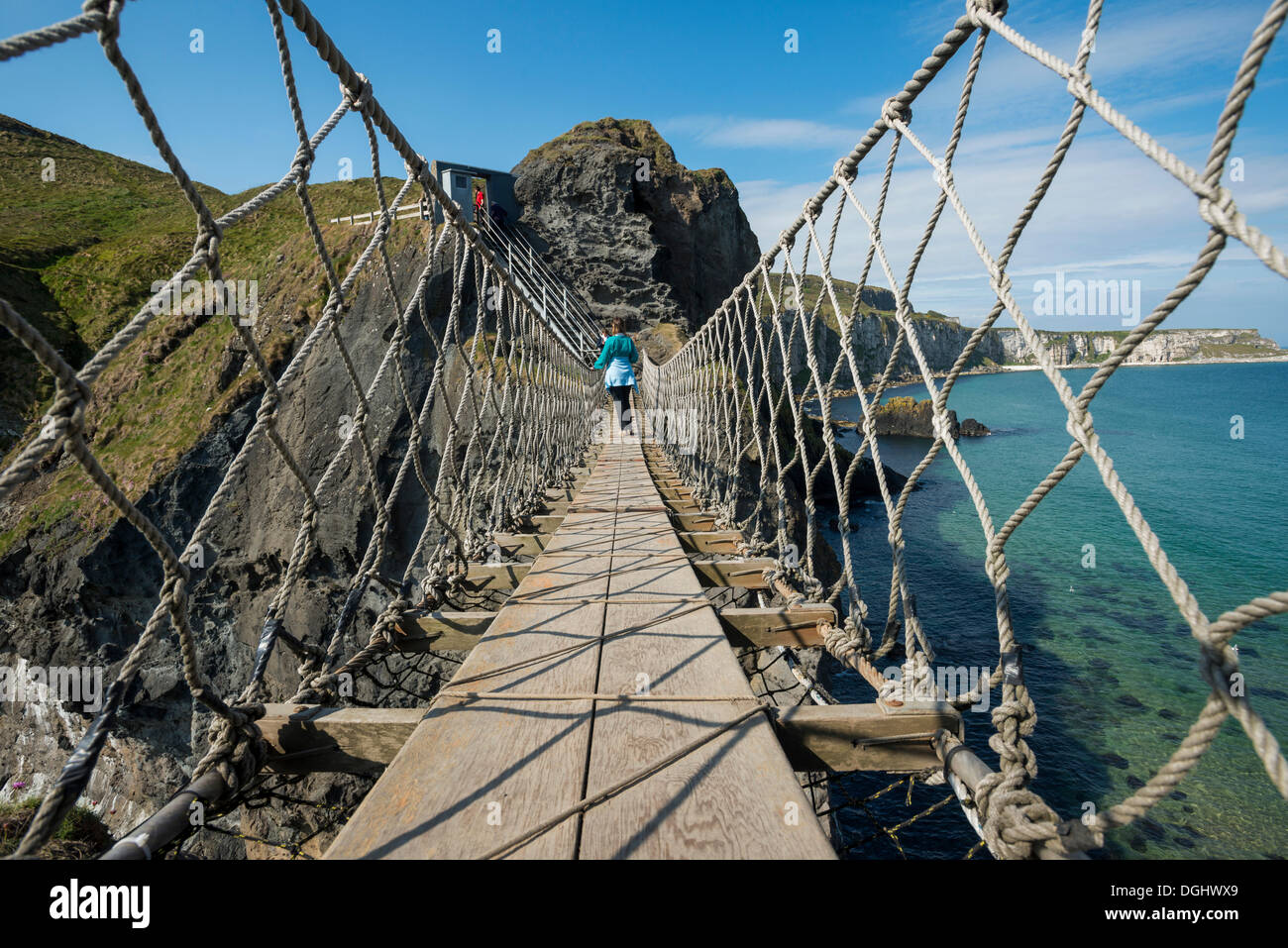 Carrick-a-Rede Bridge, woman crossing the suspension bridge, Moyle ...