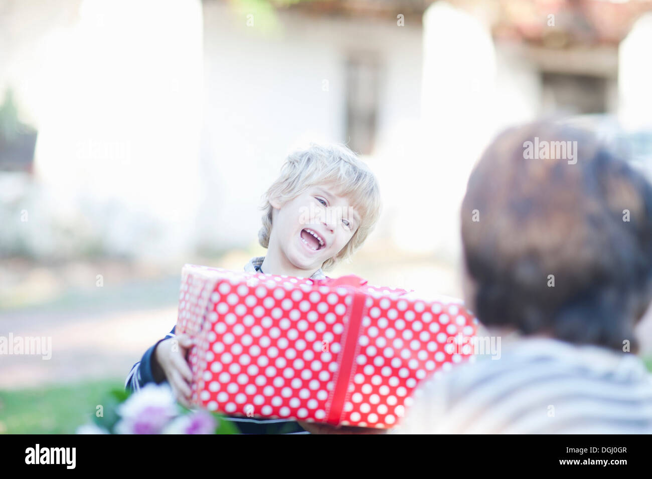 Boy holding spotty birthday gift Stock Photo - Alamy