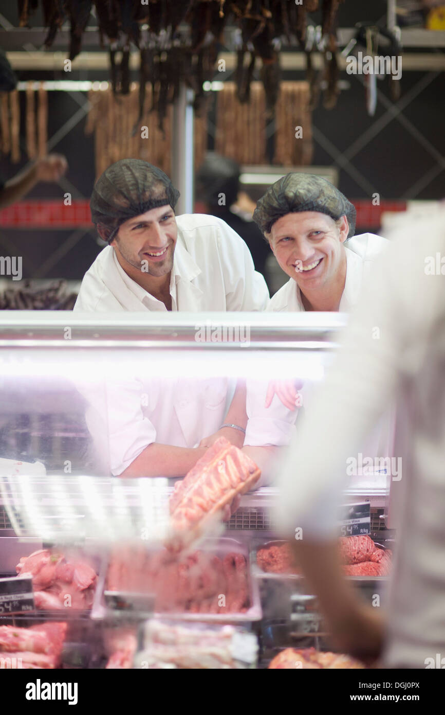 Male butchers working on counter Stock Photo - Alamy
