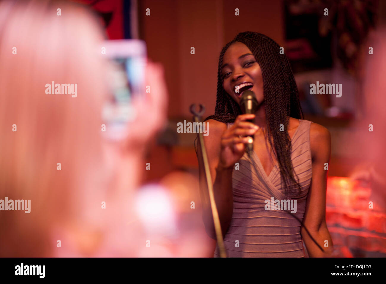 Woman singing into microphone hi-res stock photography and images - Alamy