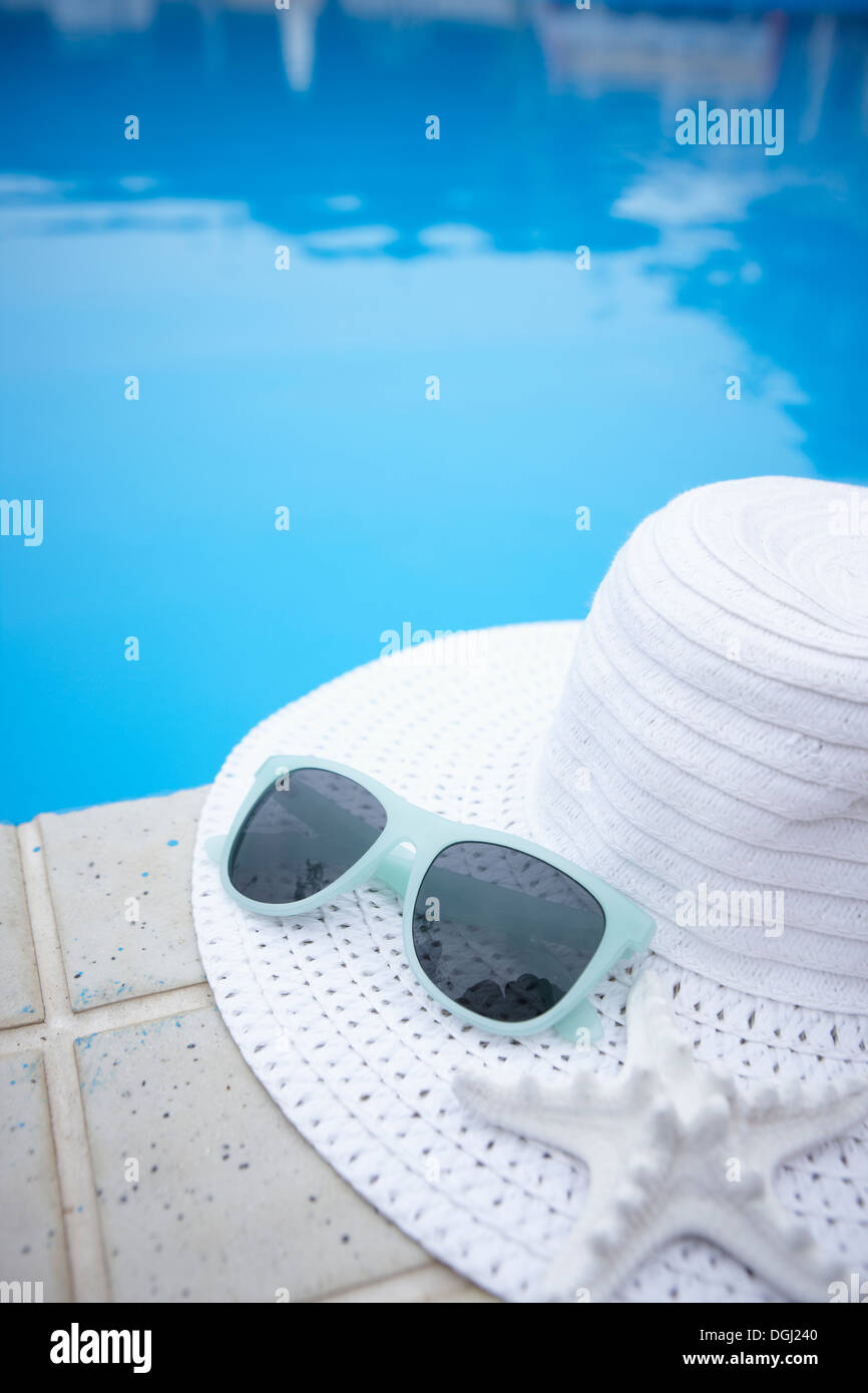 a sun hat next to the pool Stock Photo - Alamy