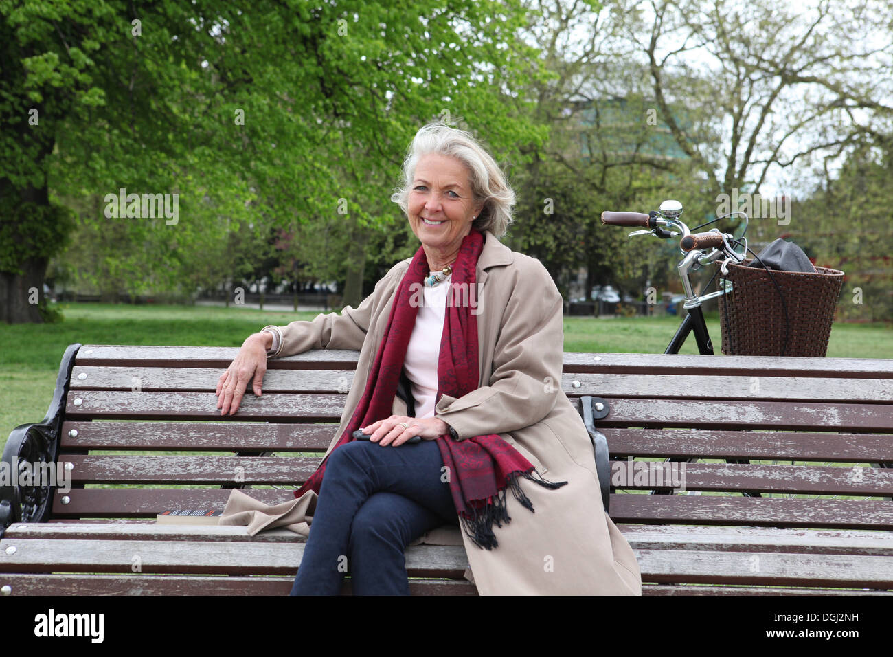 Senior woman sitting on park bench, portrait Stock Photo - Alamy