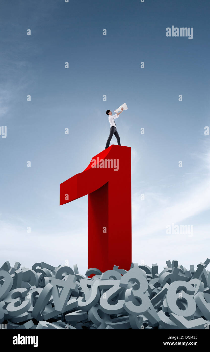a business man standing on top of the number one Stock Photo - Alamy