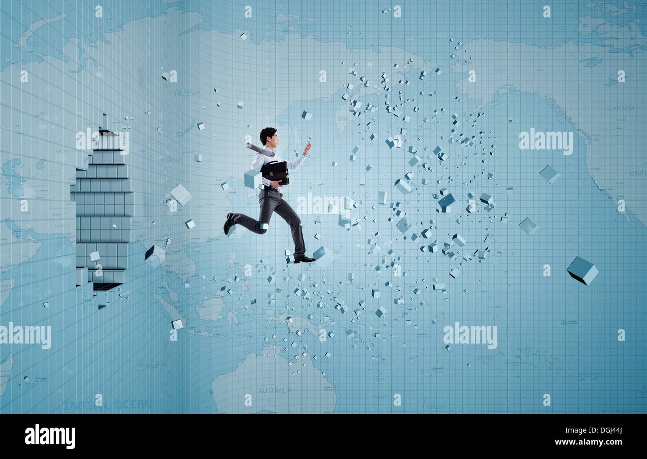 a business man running through a hole in the wall Stock Photo - Alamy