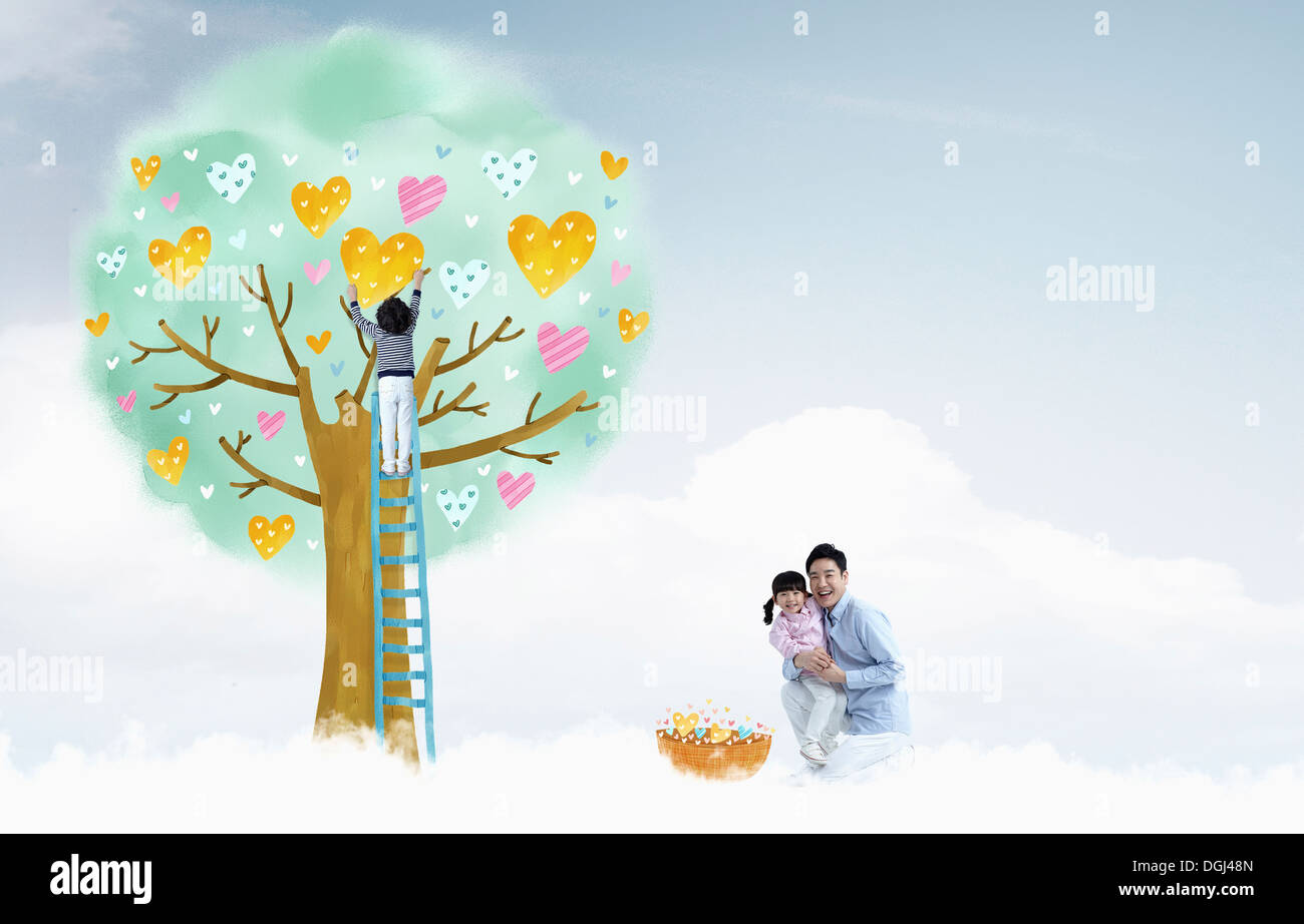 a family playing around a tree Stock Photo - Alamy