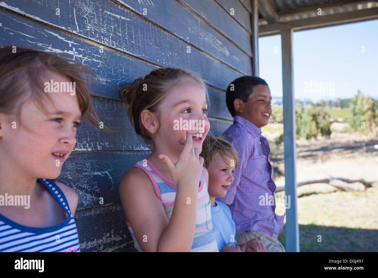 Four children outside clapboard cabin Stock Photo - Alamy