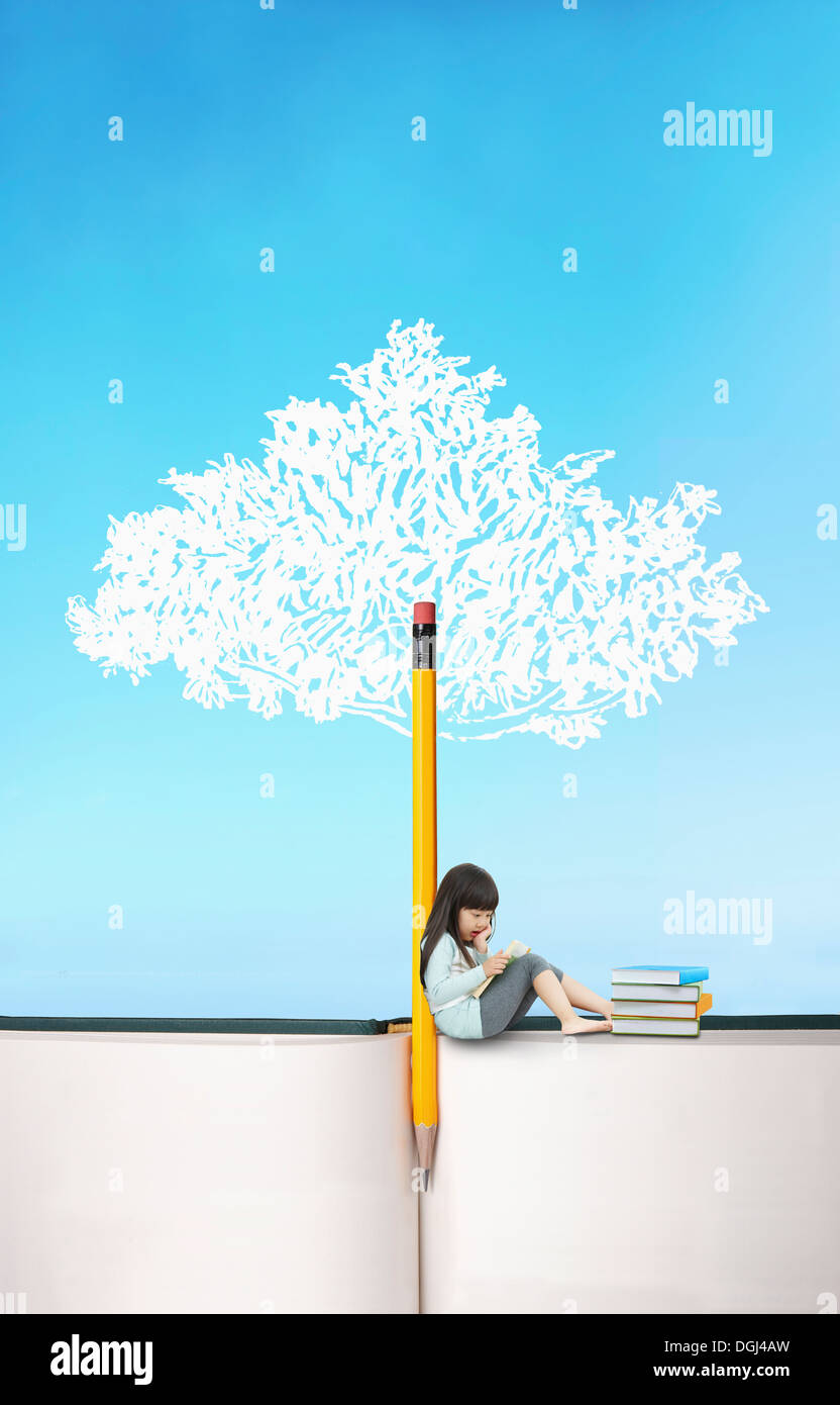 a girl reading books under a tree Stock Photo - Alamy