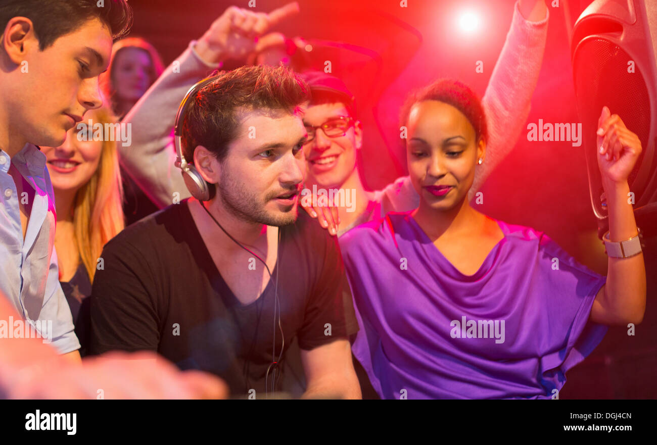 Group of people dancing at party, man wearing headphones Stock Photo ...