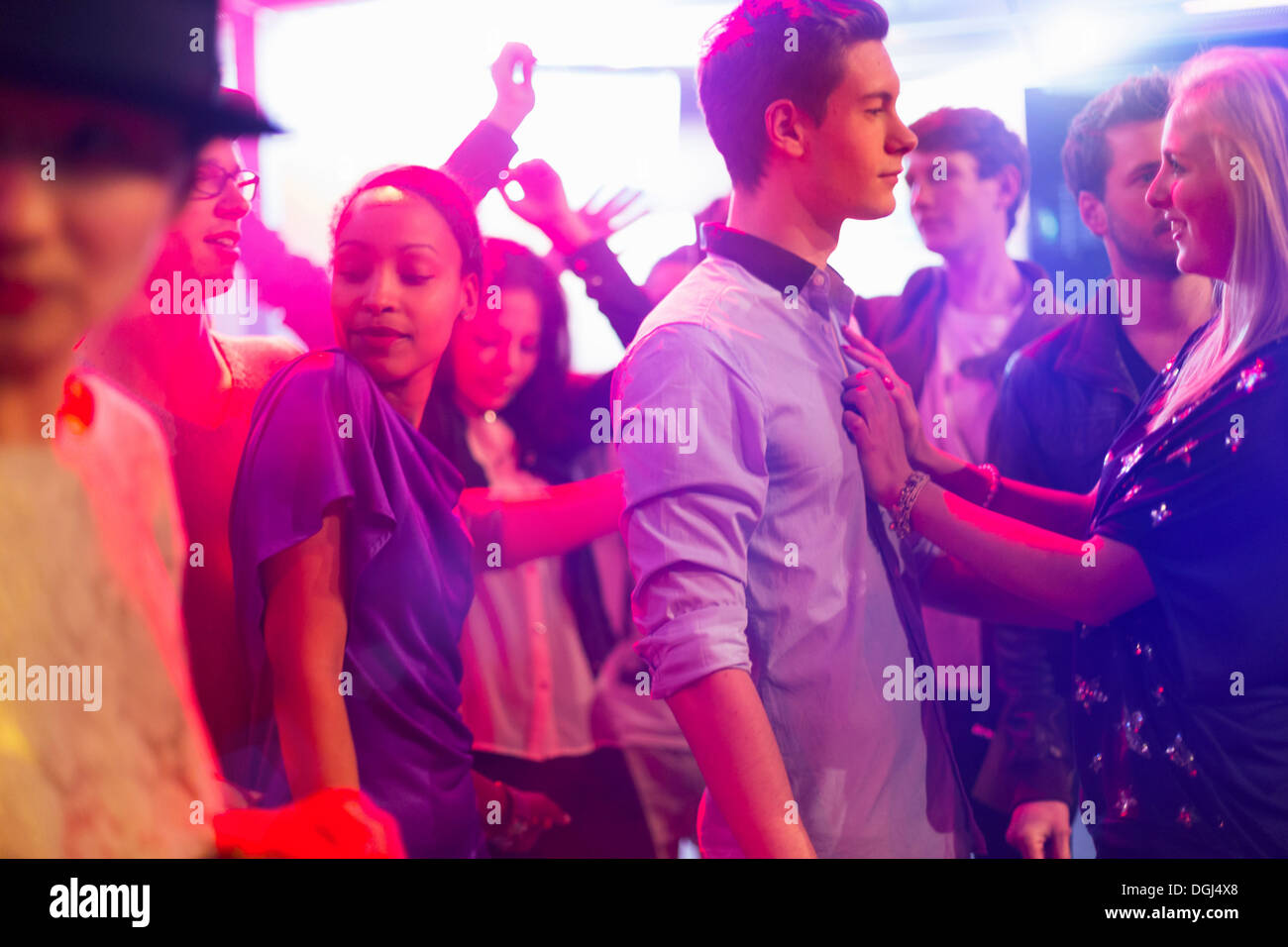 Teenage girl with hands on boy's chest at party Stock Photo - Alamy