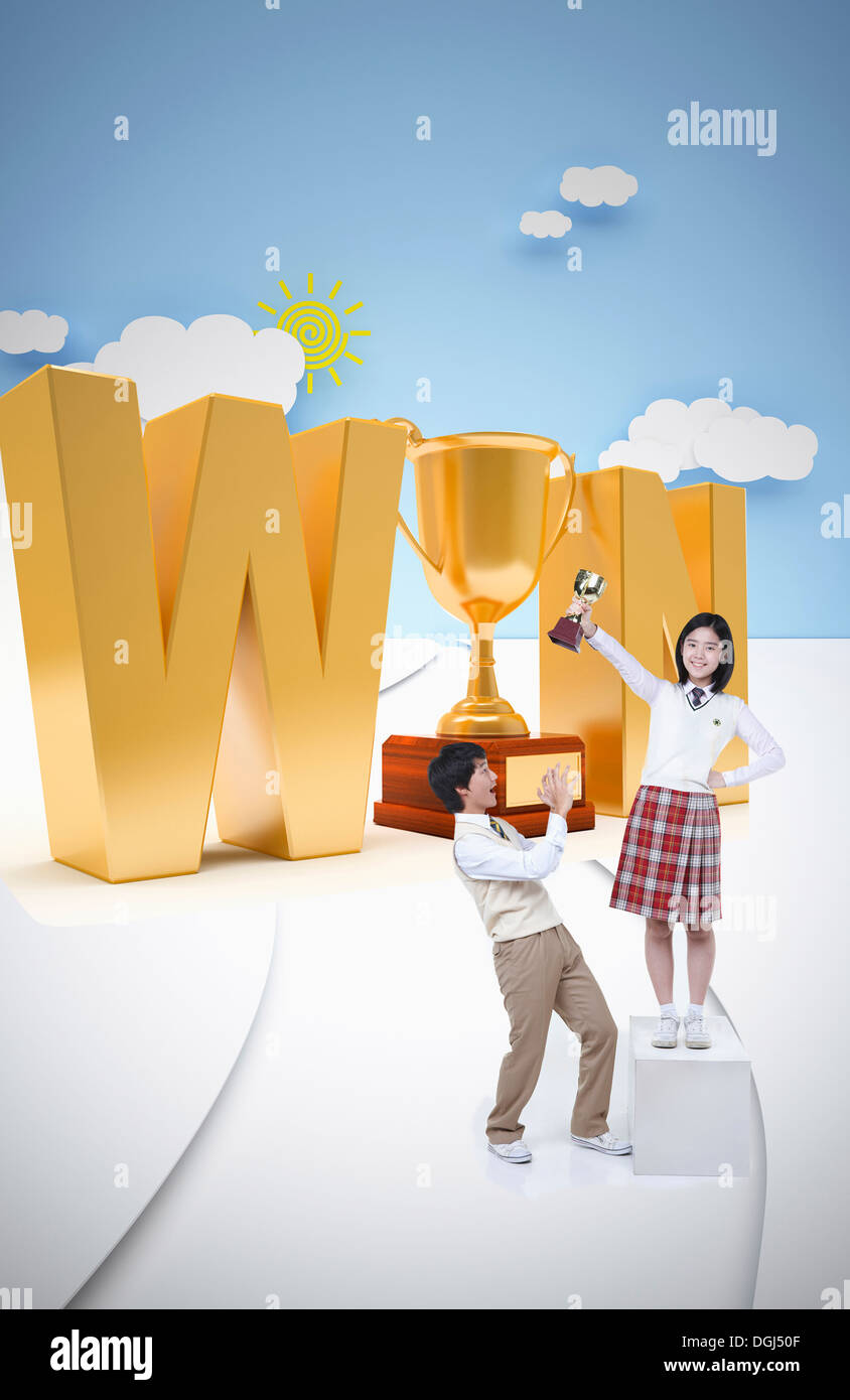 a school boy and a school girl holding a heavy trophy Stock Photo - Alamy