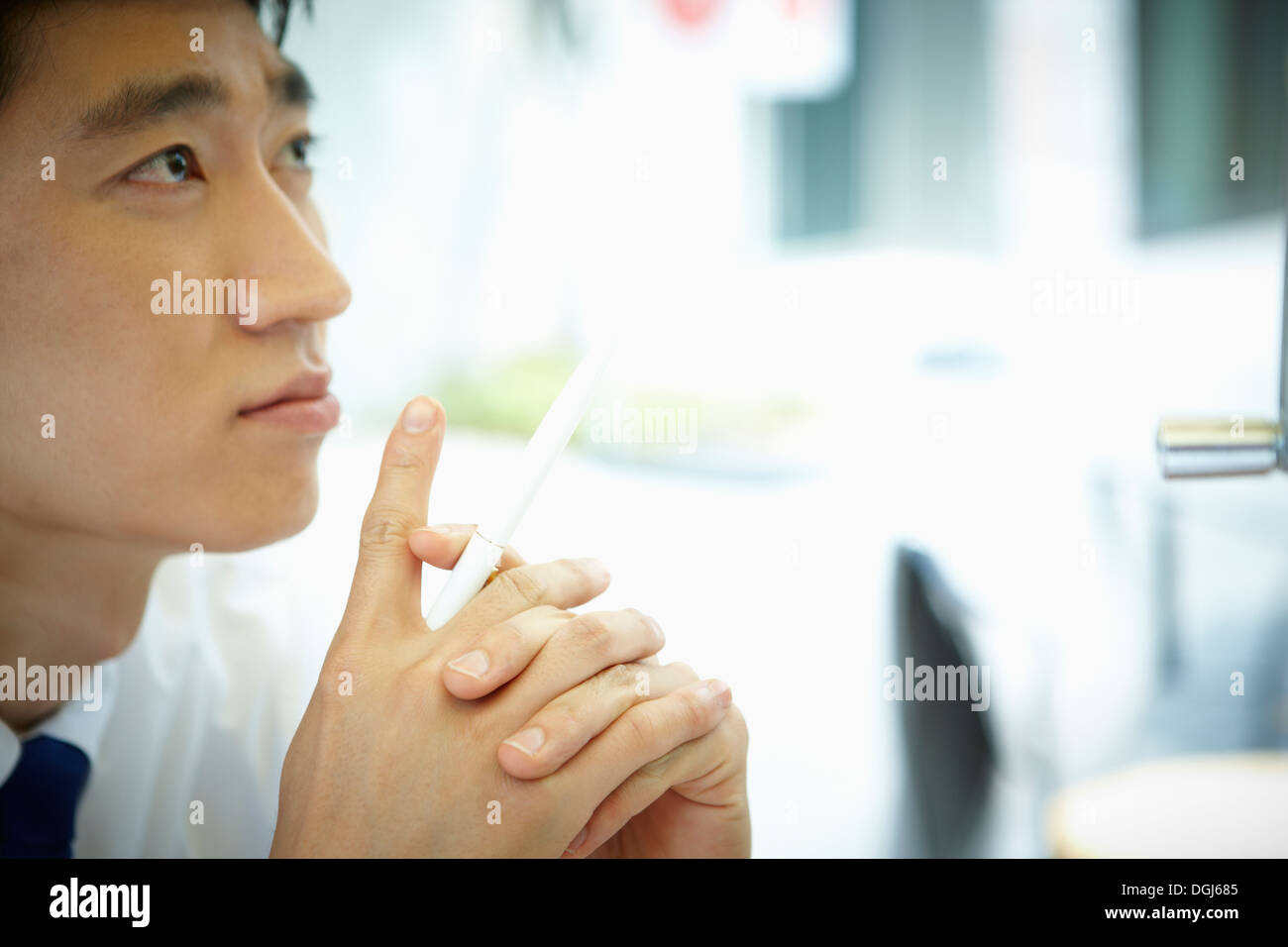 a man thinking with his fingers crossed Stock Photo - Alamy