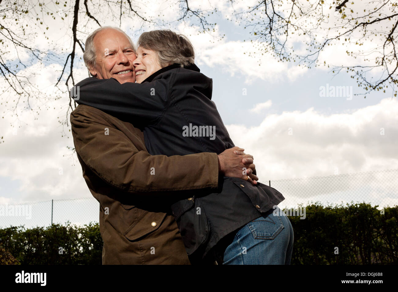 Wife hugging husband round neck Stock Photo - Alamy