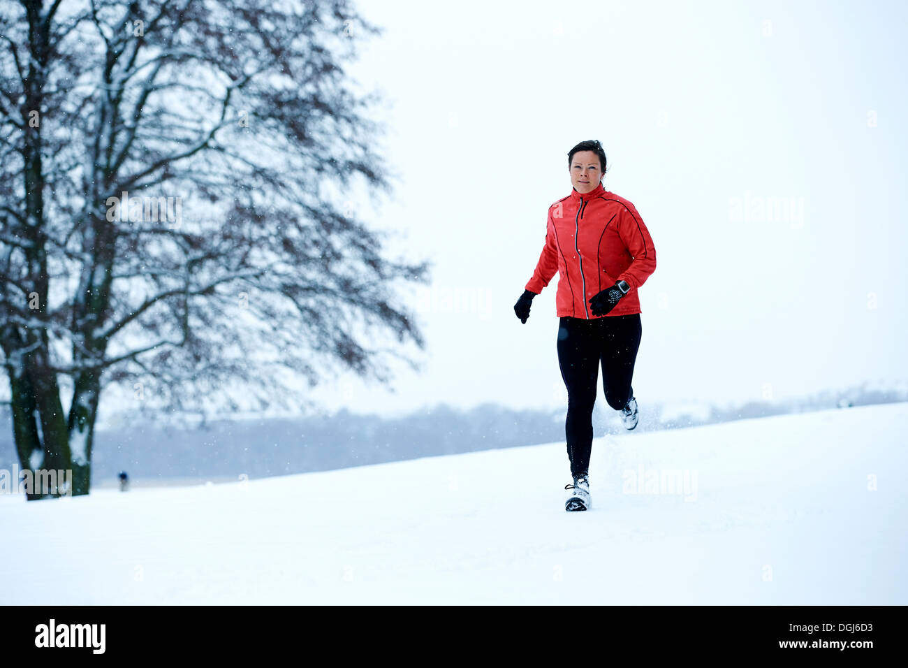 Woman snow running Stock Photo - Alamy