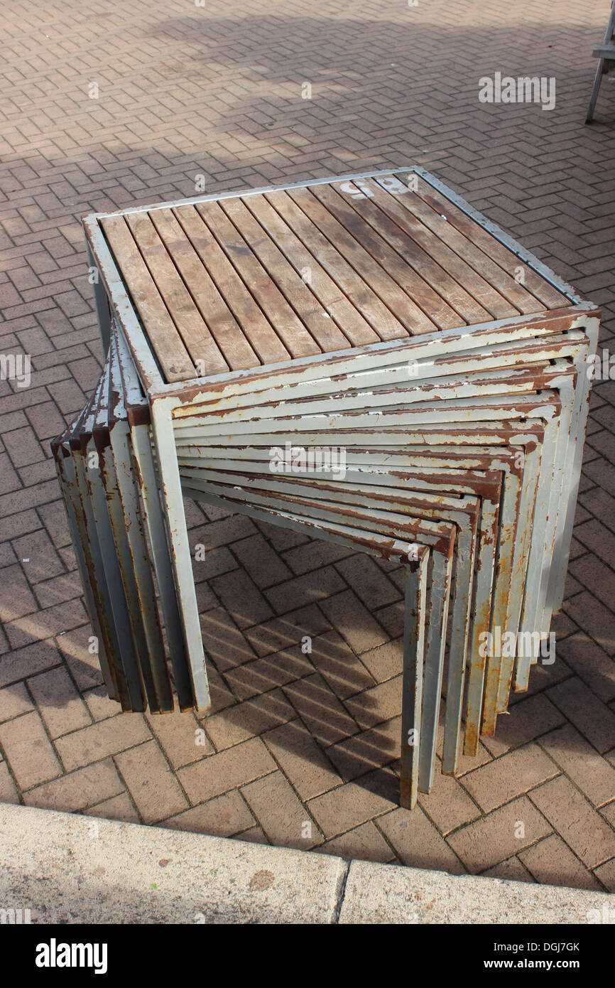 Stacked tables going rusty Stock Photo - Alamy