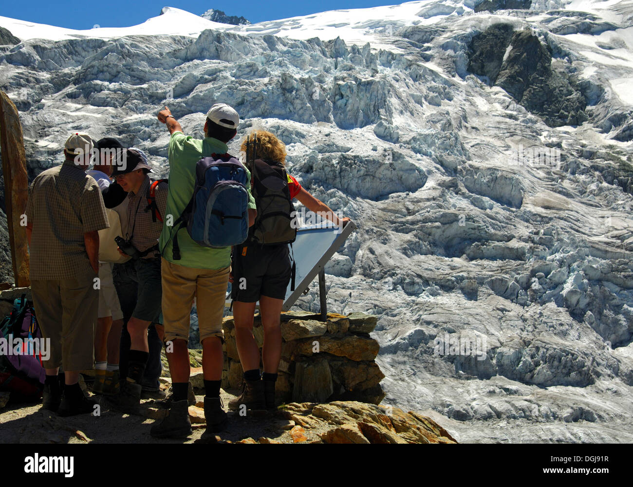 Hikers viewing the ice rifts of Moiry Glacier from the Moiry Hut ...