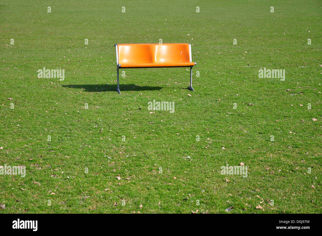 Orange bench on lawn Stock Photo - Alamy