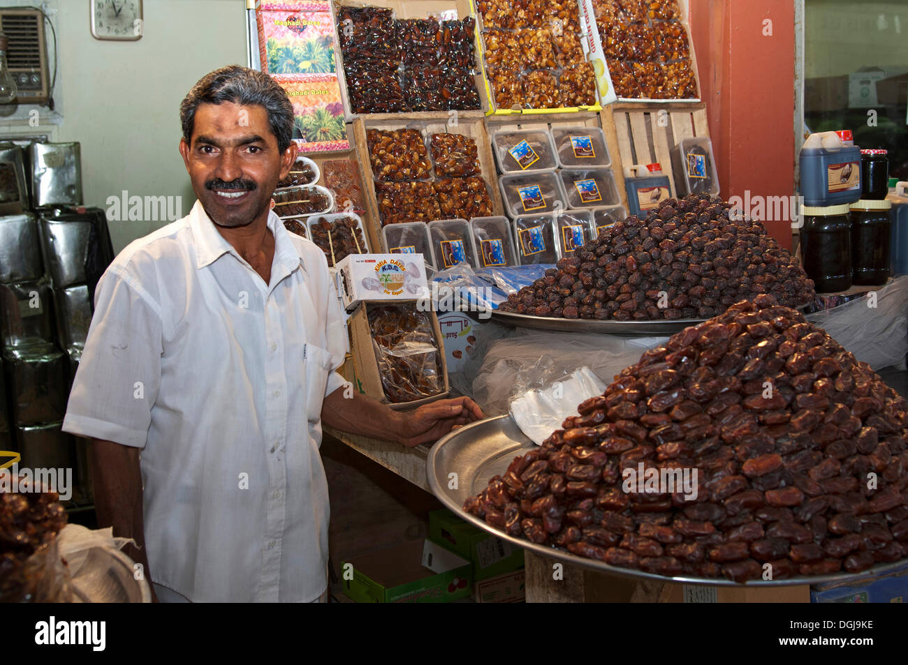Salesman at his market stall selling dates, green market at Sharjah ...