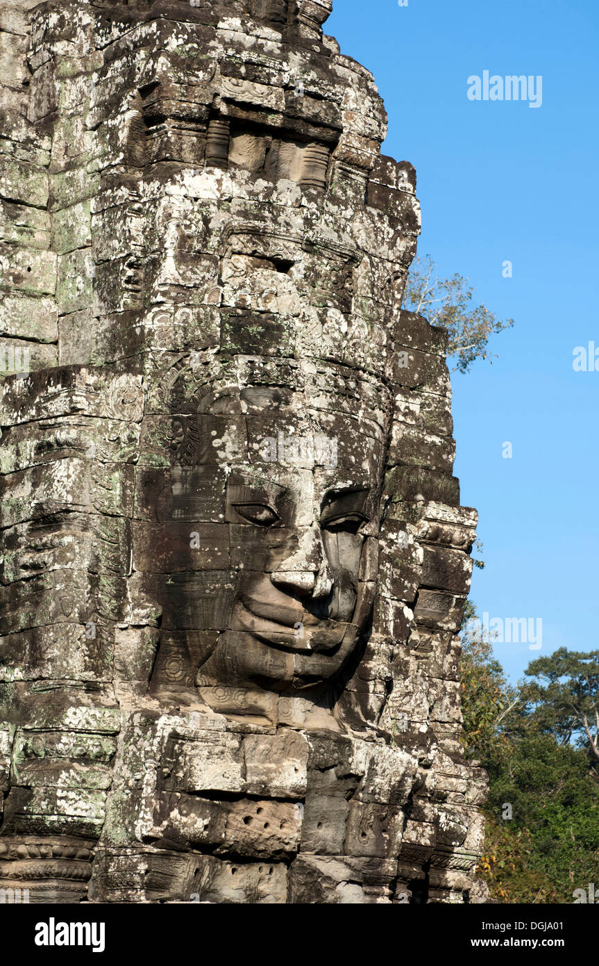 Smile of Angkor, huge face carved in stone on a tower, Bayon Temple ...