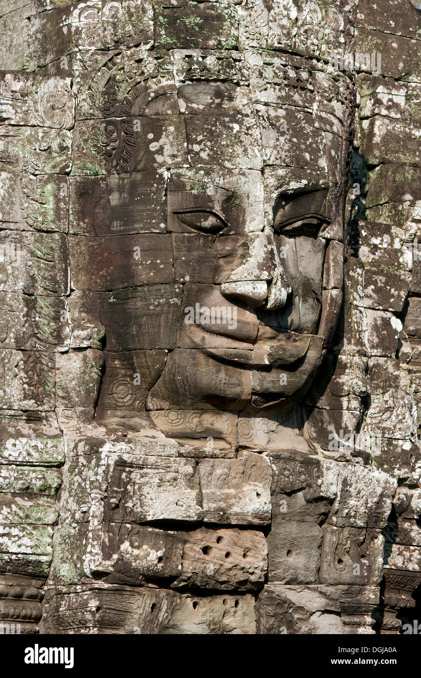 Smile of Angkor, huge face carved in stone on a tower, Bayon Temple ...