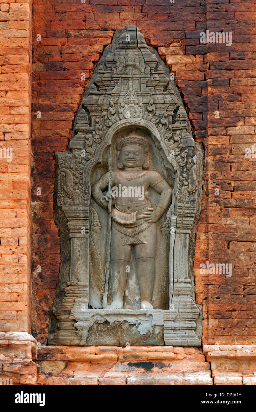 Bas-relief of a male guardian figure holding a trident-spear in his ...
