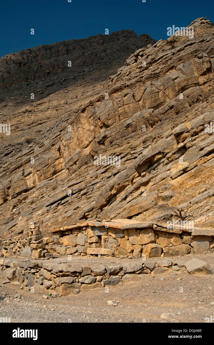 Bedouin stone house matching in colour and texture to the foot of a ...