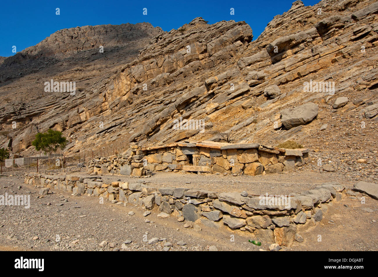 Bedouin stone house matching in colour and texture to the foot of a ...