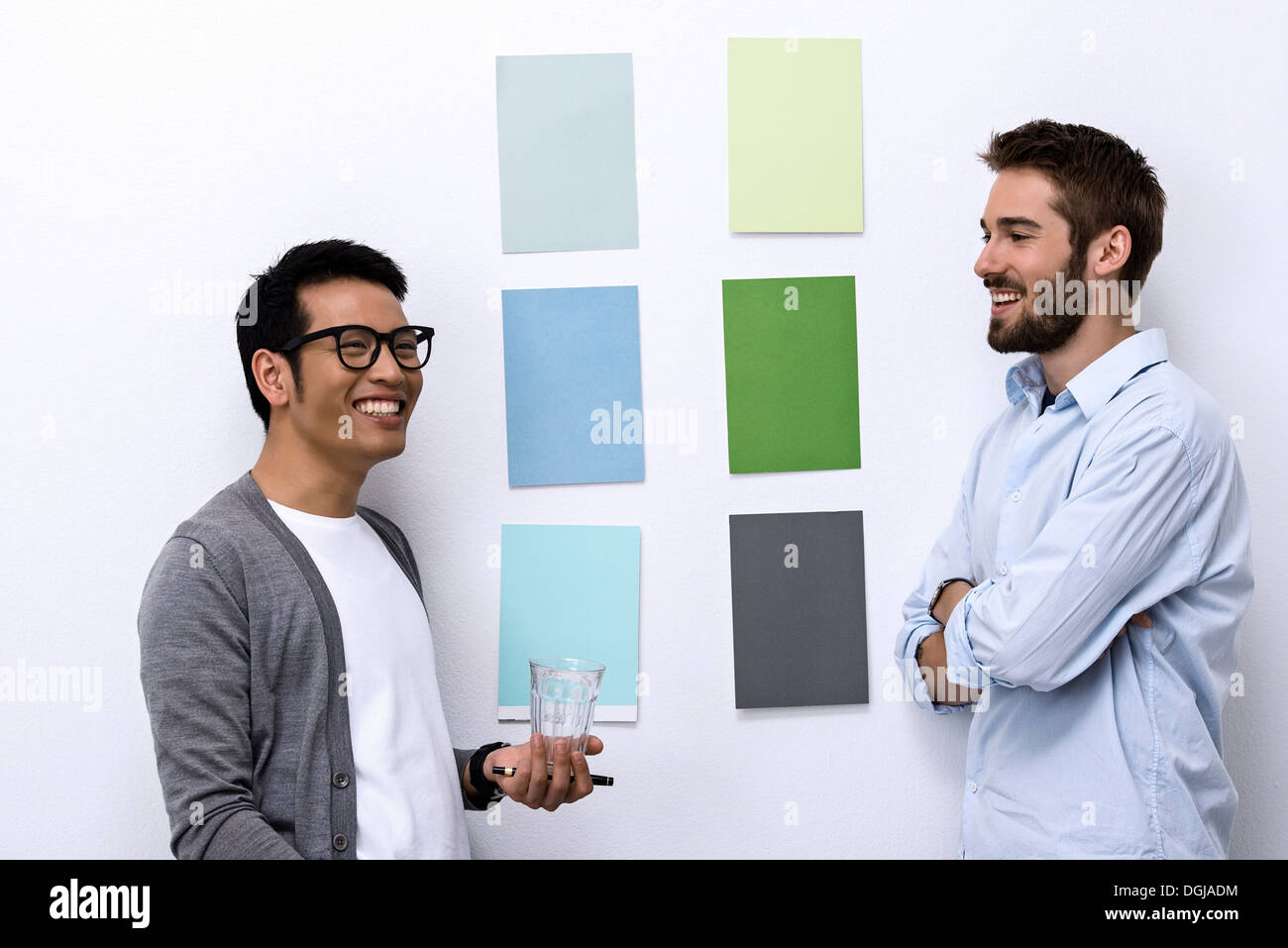 Male designers standing in front of color swatch Stock Photo - Alamy