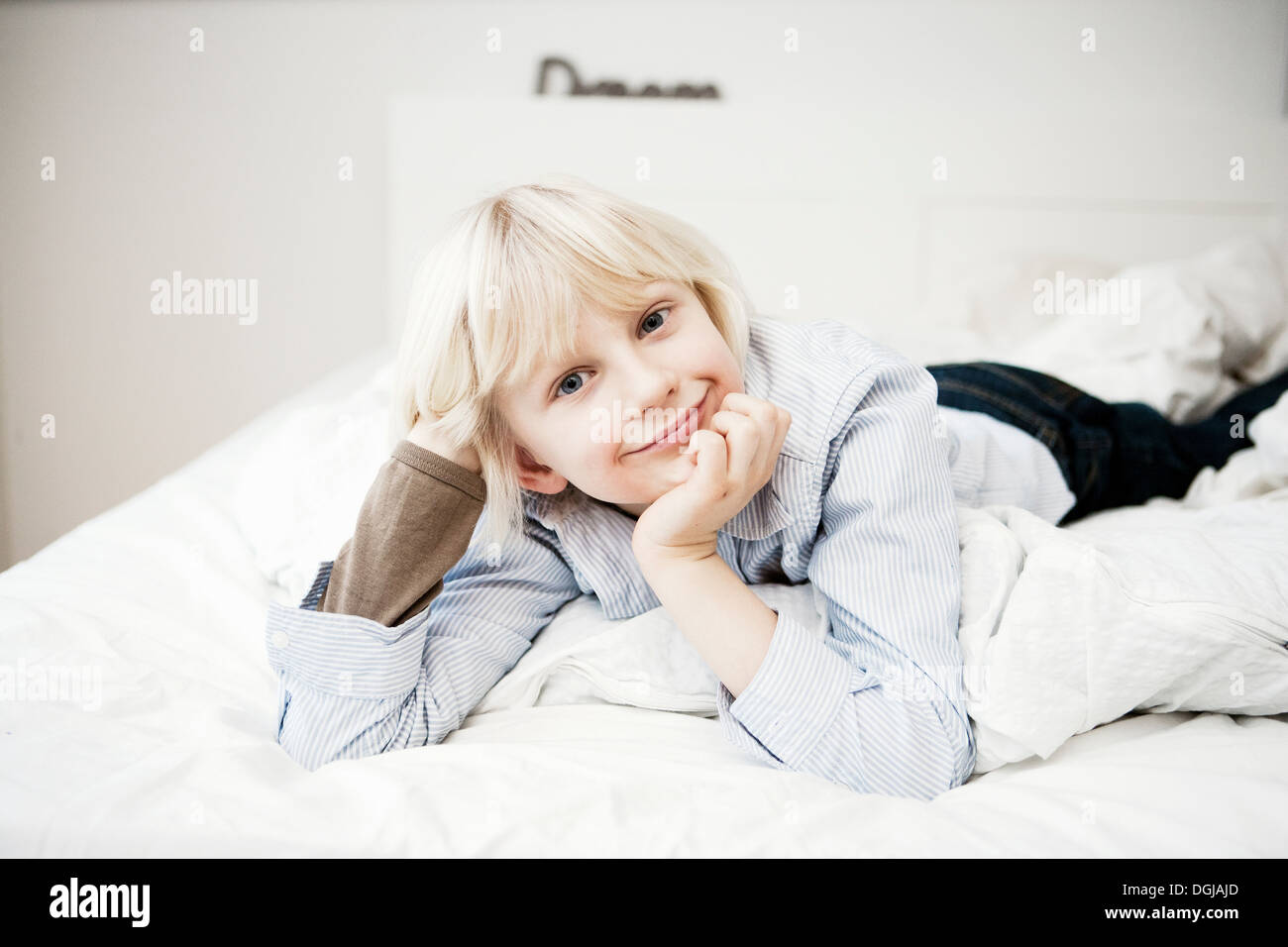 Portrait of young boy lying on bed Stock Photo: 61869093 - Alamy Portrait of young boy lying on bed Stock Photo: 61869093 - Alamy