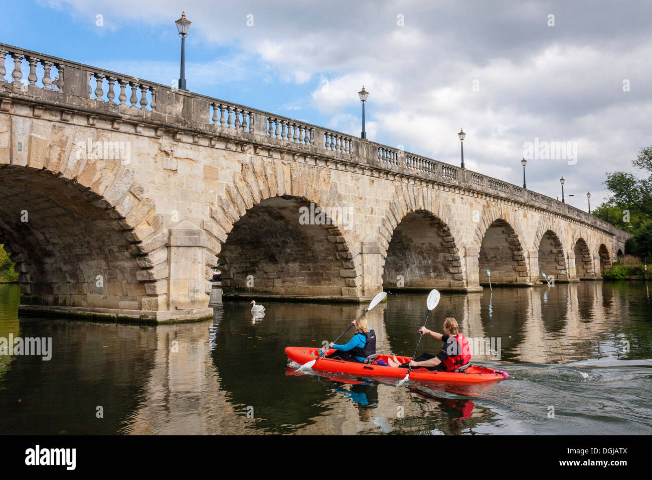 Couple canoeing along River Thames under Maidenhead Bridge, Berkshire ...