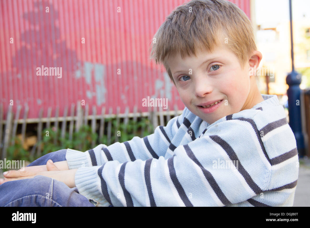 Close up portrait of boy sitting outside Stock Photo - Alamy