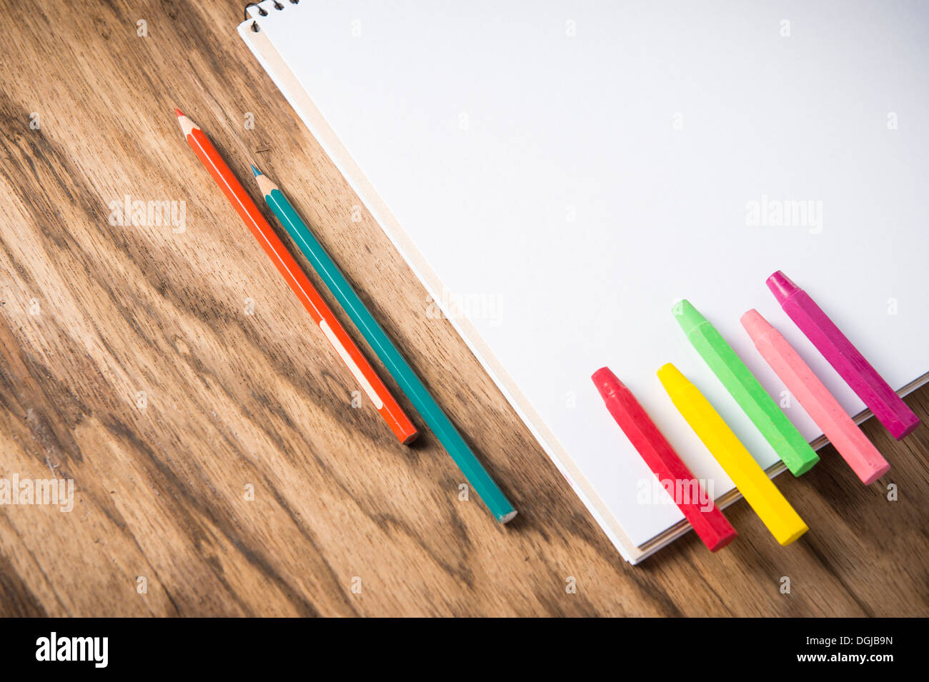 different color pens attached to a note book Stock Photo - Alamy