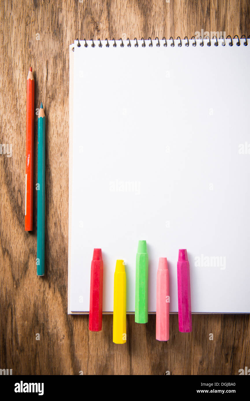 different color pens attached to a note book Stock Photo - Alamy