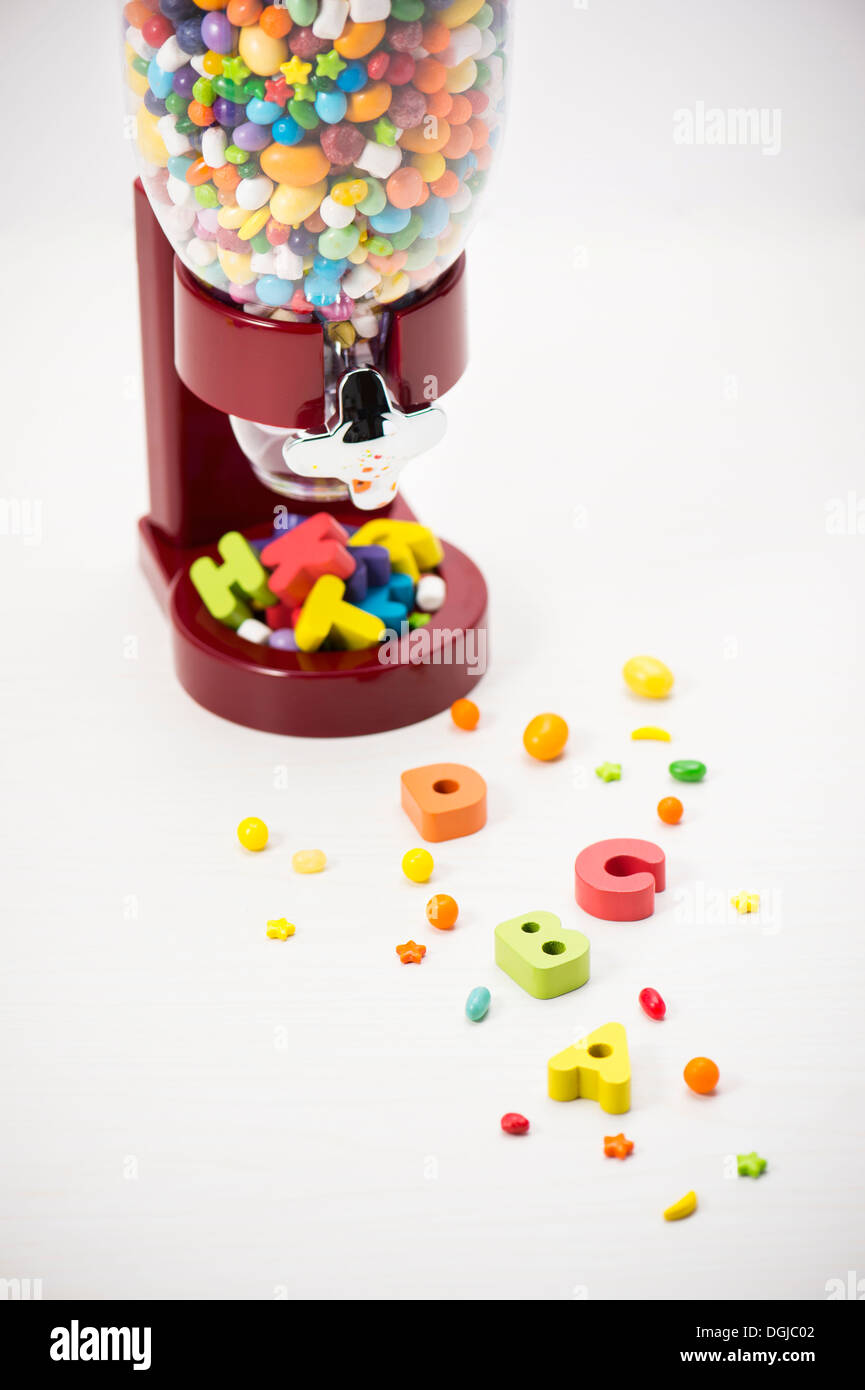 a candy machine with different color alphabets Stock Photo - Alamy