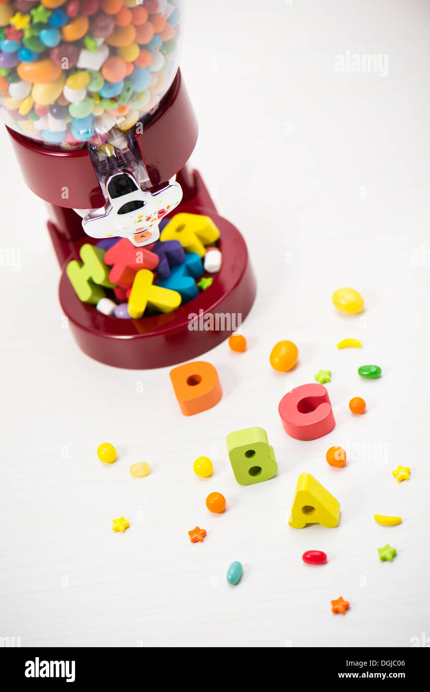 a candy machine with different color alphabets Stock Photo - Alamy