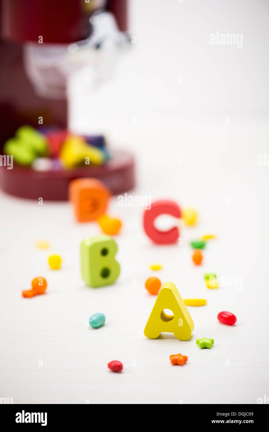 a candy machine with different color alphabets Stock Photo - Alamy
