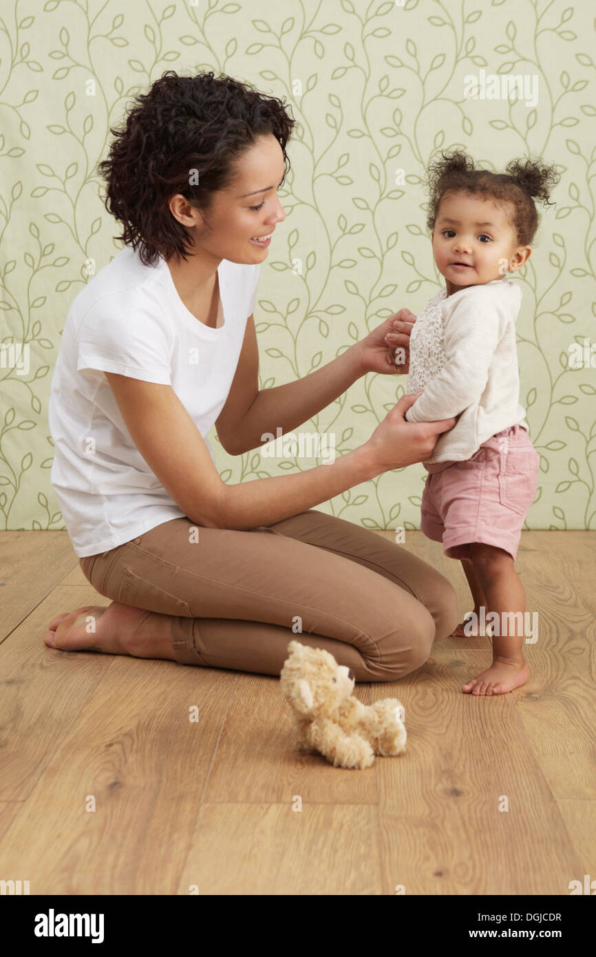 Mother holding baby girl taking first steps Stock Photo - Alamy