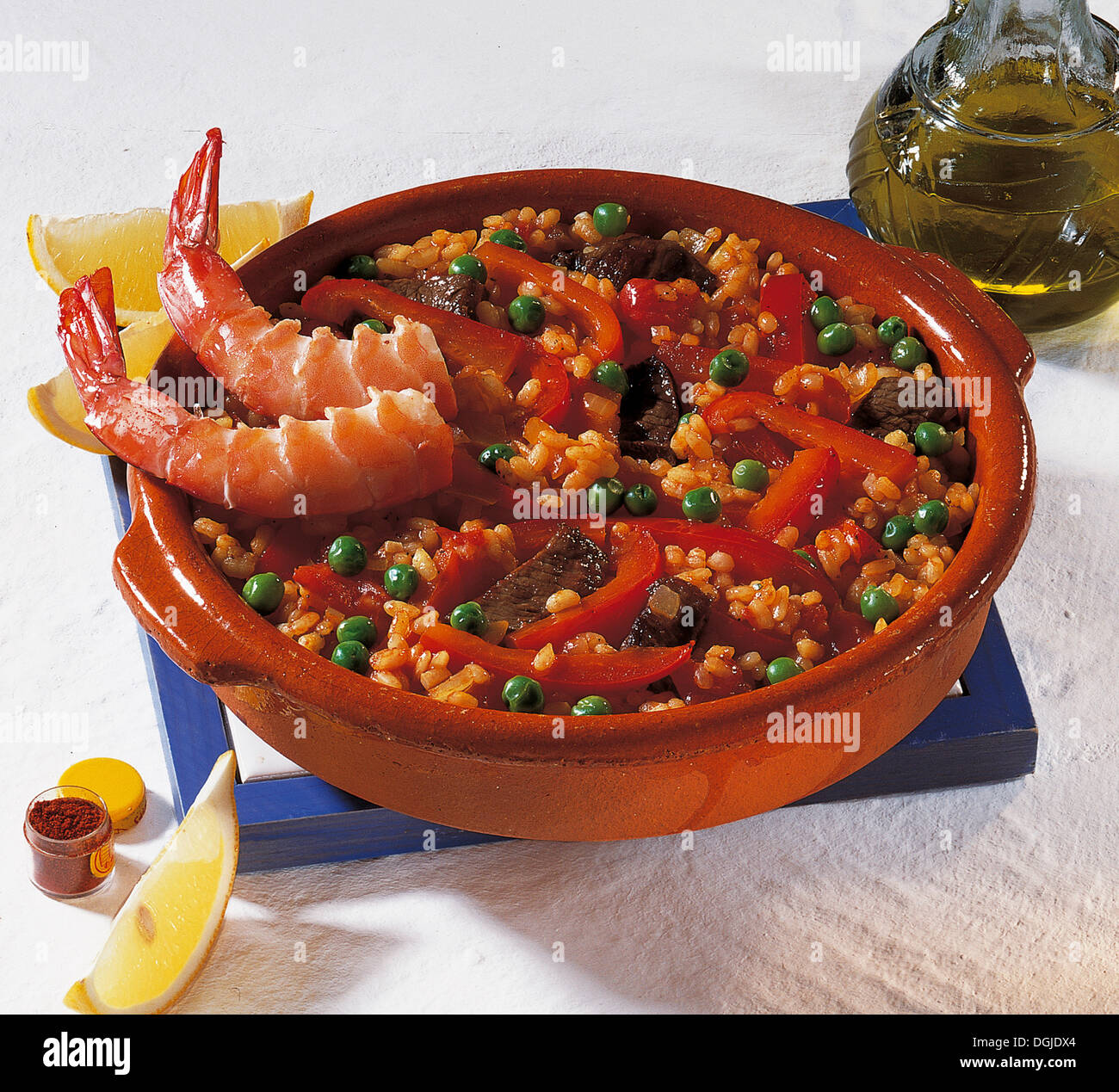 Wild boar paella with peppers, peas, tomatoes, round-grain rice and ...