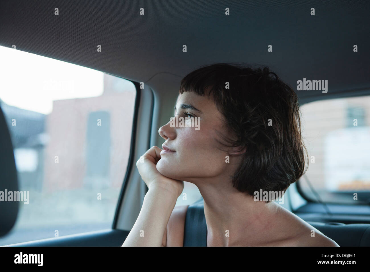 Young woman looking out of car window Stock Photo - Alamy